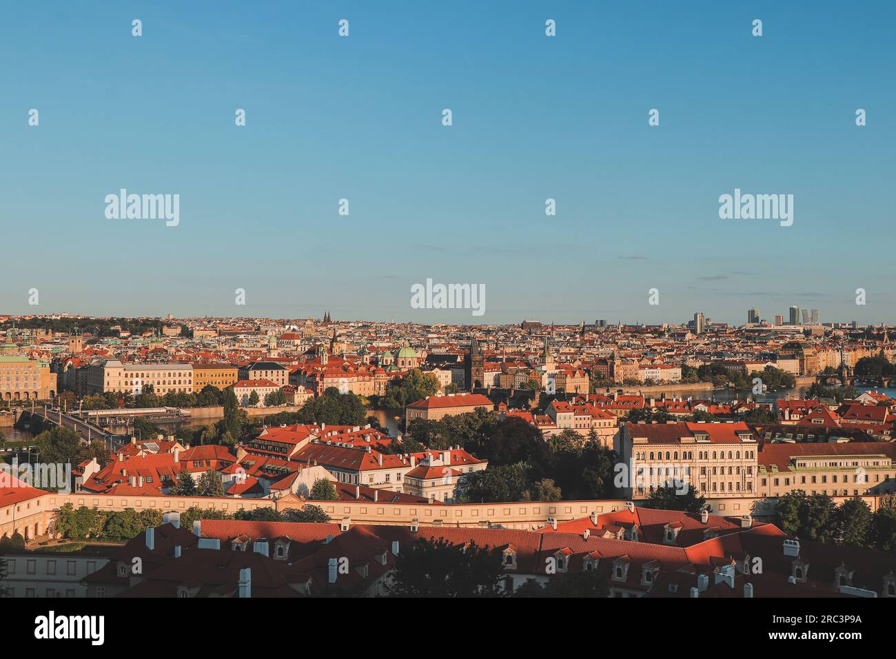 Old Town of Prague under the warm rays of the setting sun illuminating ...