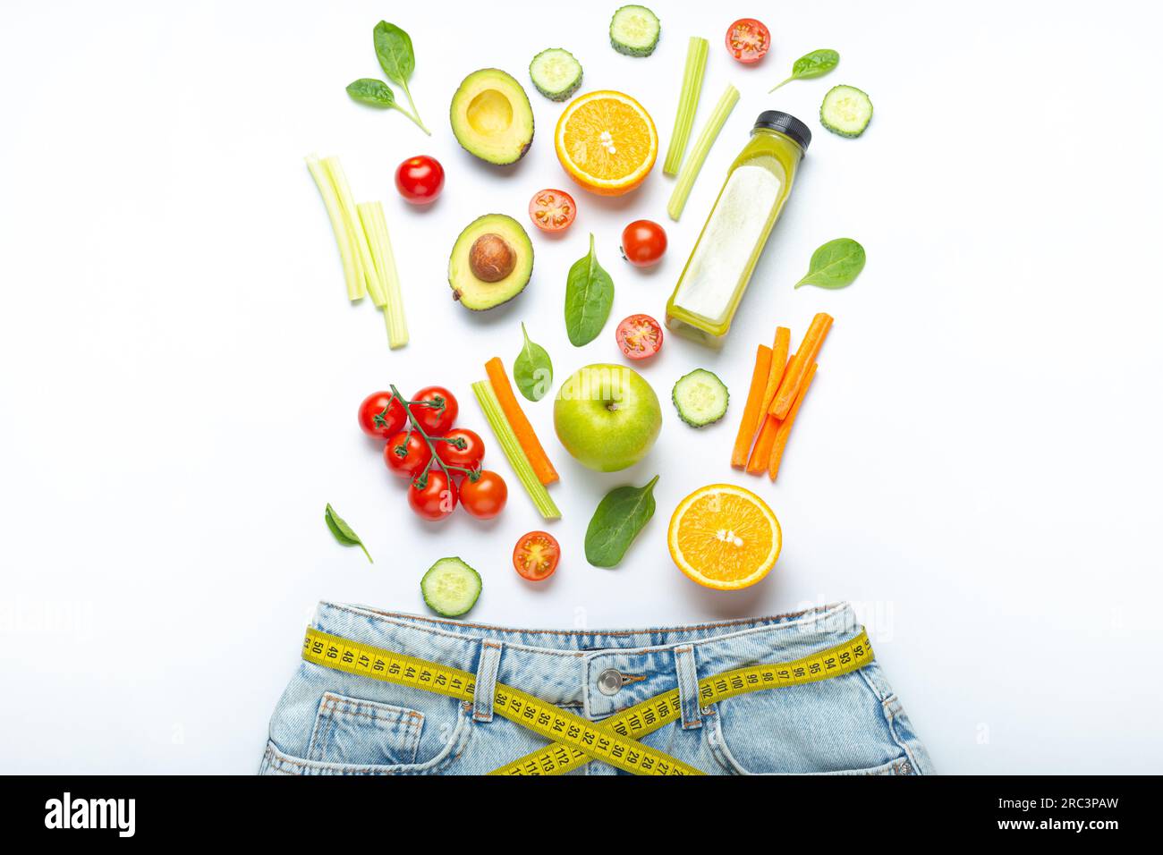 Fresh fruit, vegetables, smoothie falling into jeans and yellow ...