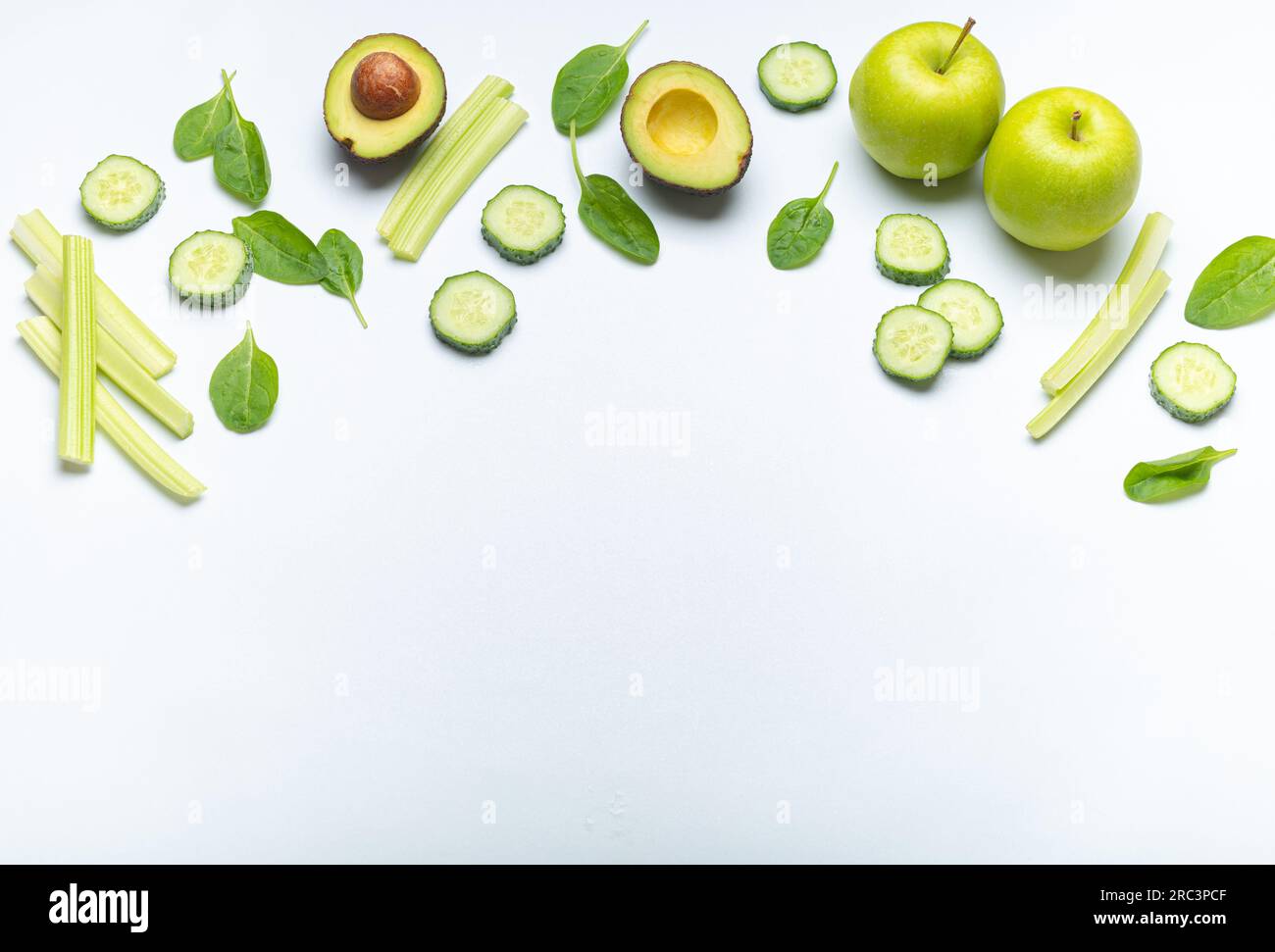 Healthy food border with green fresh vegetables and fruit on simple ...