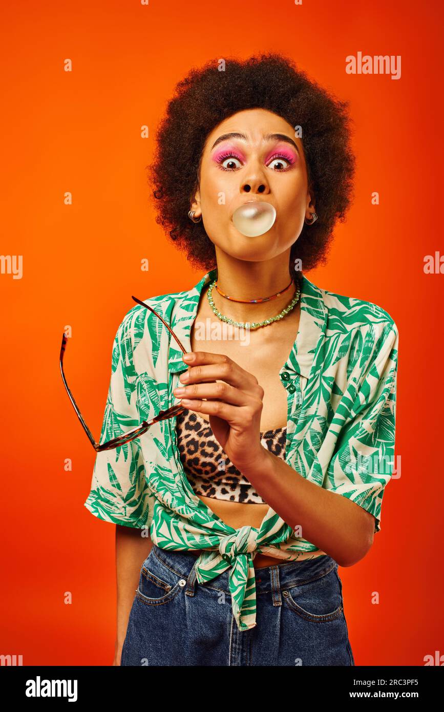 Portrait of excited young african american woman with bold makeup ...