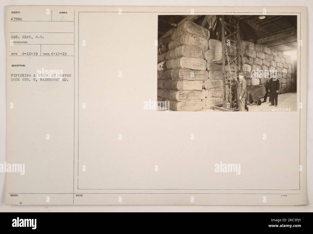Soldiers stacking canvas duck in Section G of Warehouse M2, located at ...