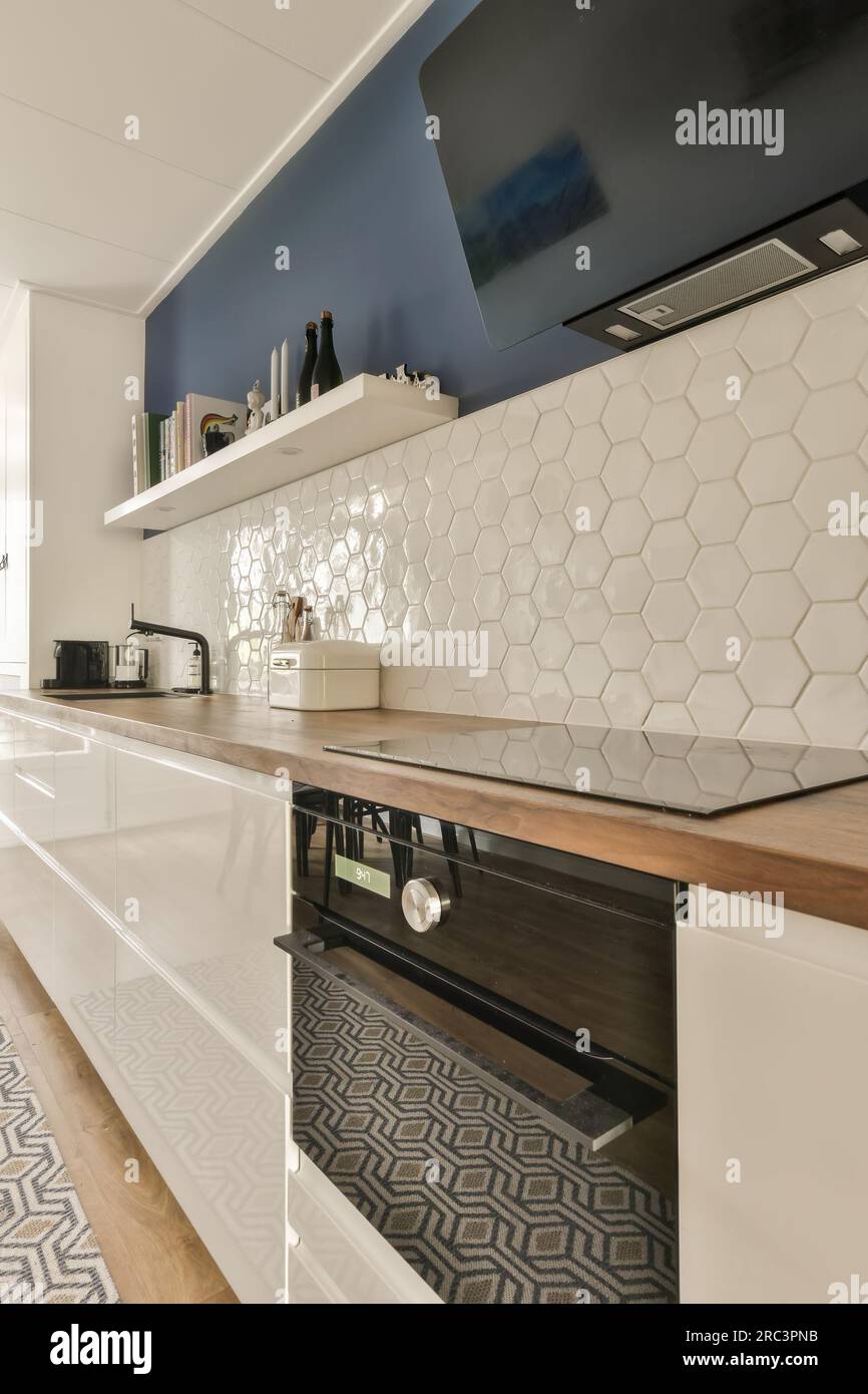 a modern kitchen with hexagon tiles on the backs and wood countertops ...