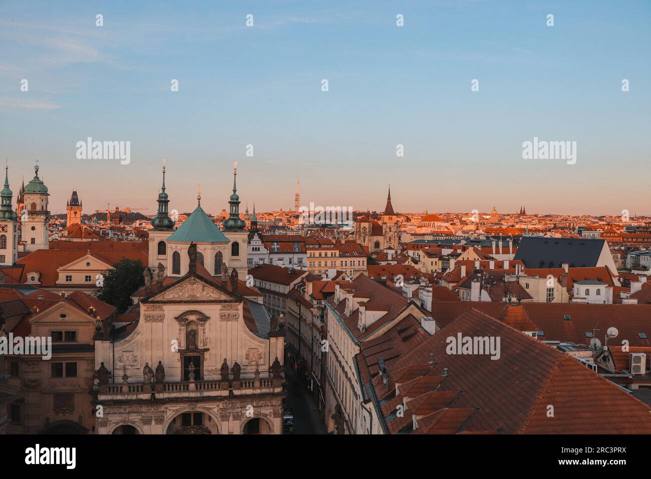 Old Town of Prague under the warm rays of the setting sun illuminating ...