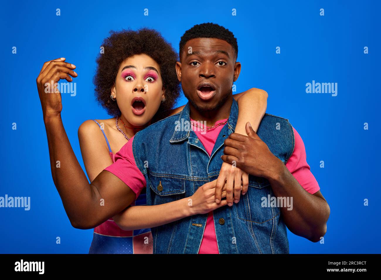 Shocked young african american woman with bold makeup hugging best ...