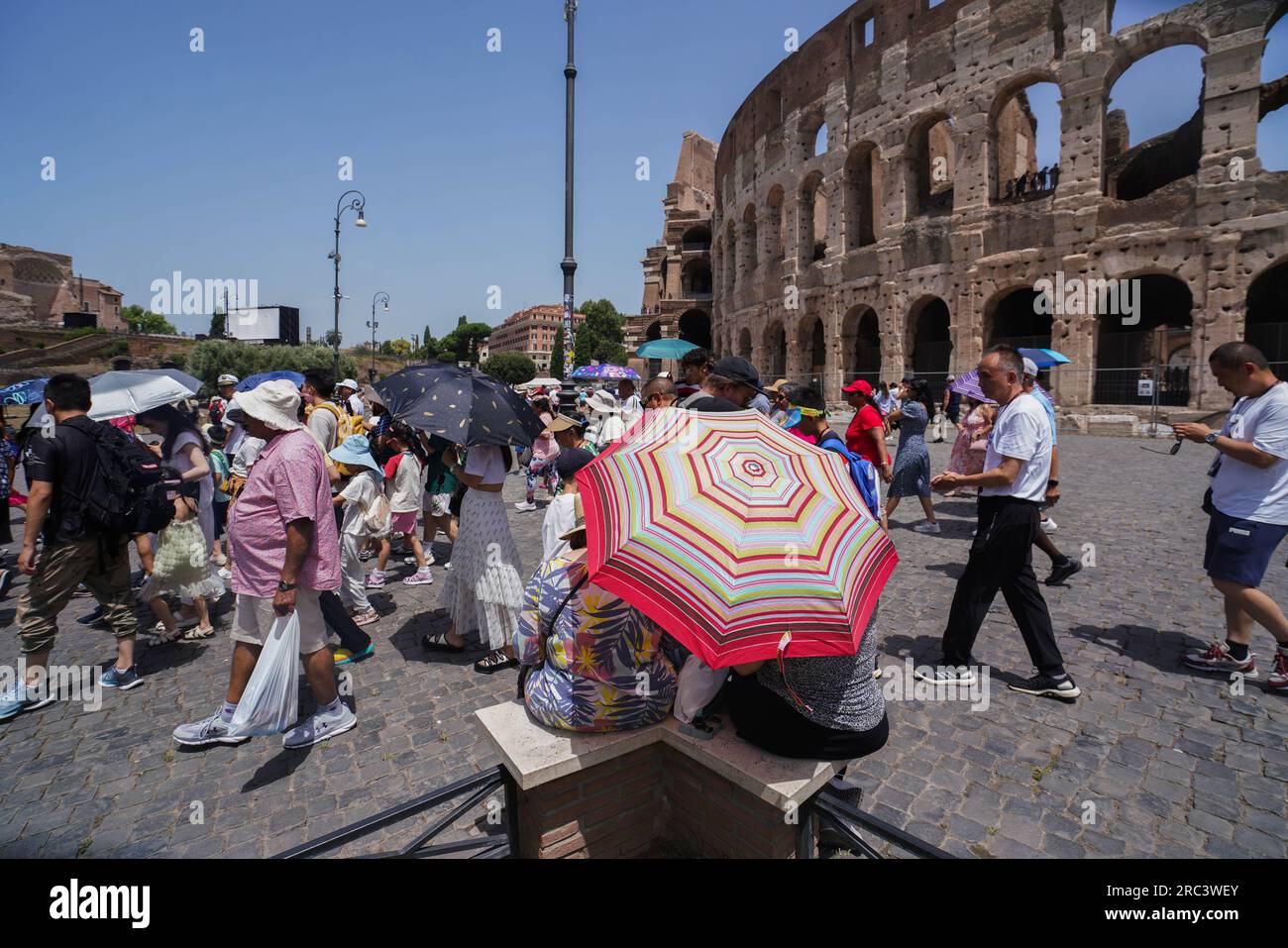 Rome, Italy. 12 July 2023 Tourists at the Roman colloseum shelter ...