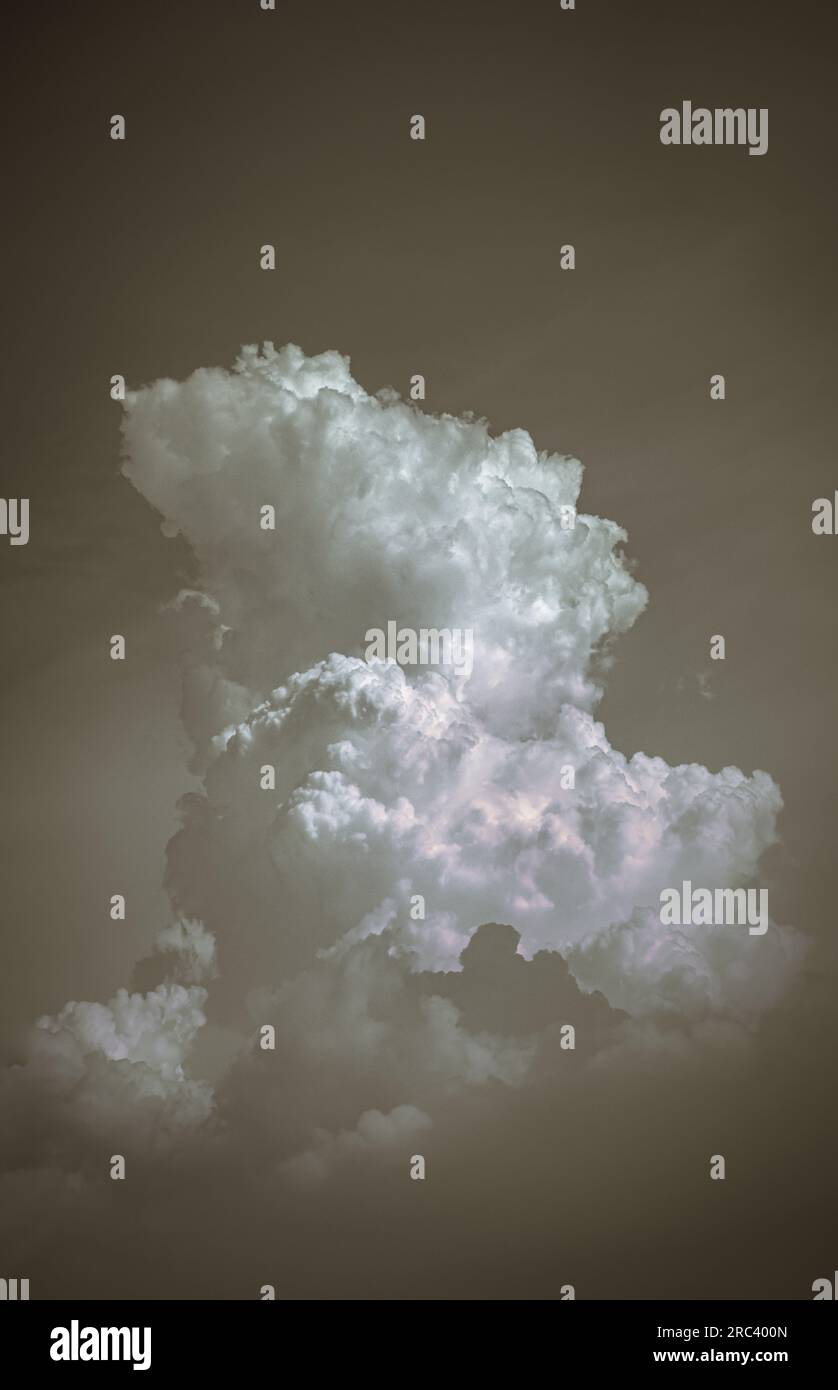 Dramatic cloud formation with interesting light and shadow against dull ...