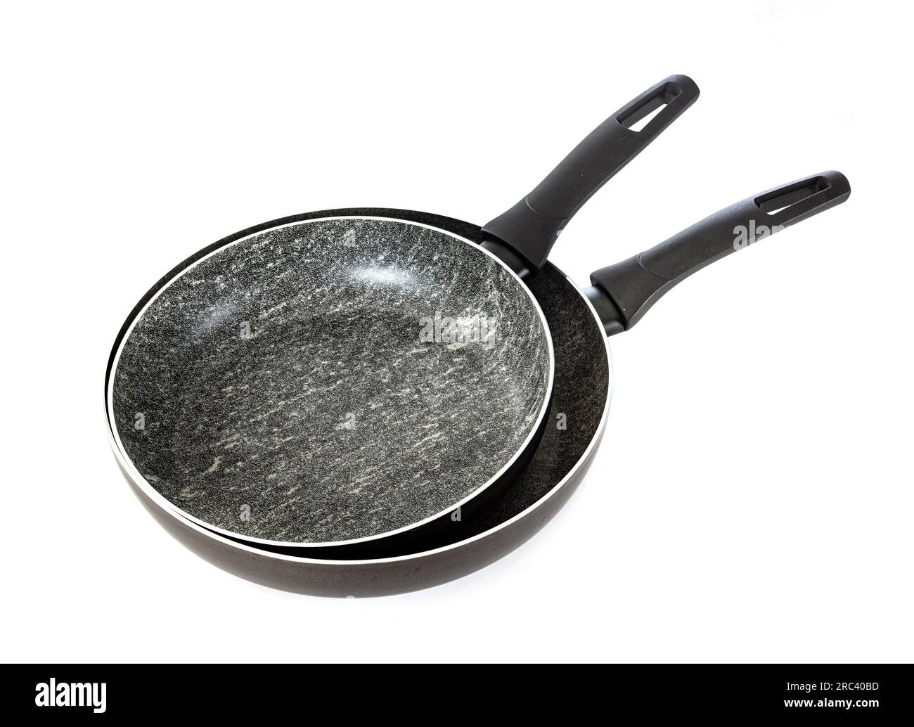 black frying pans in front of white background Stock Photo - Alamy