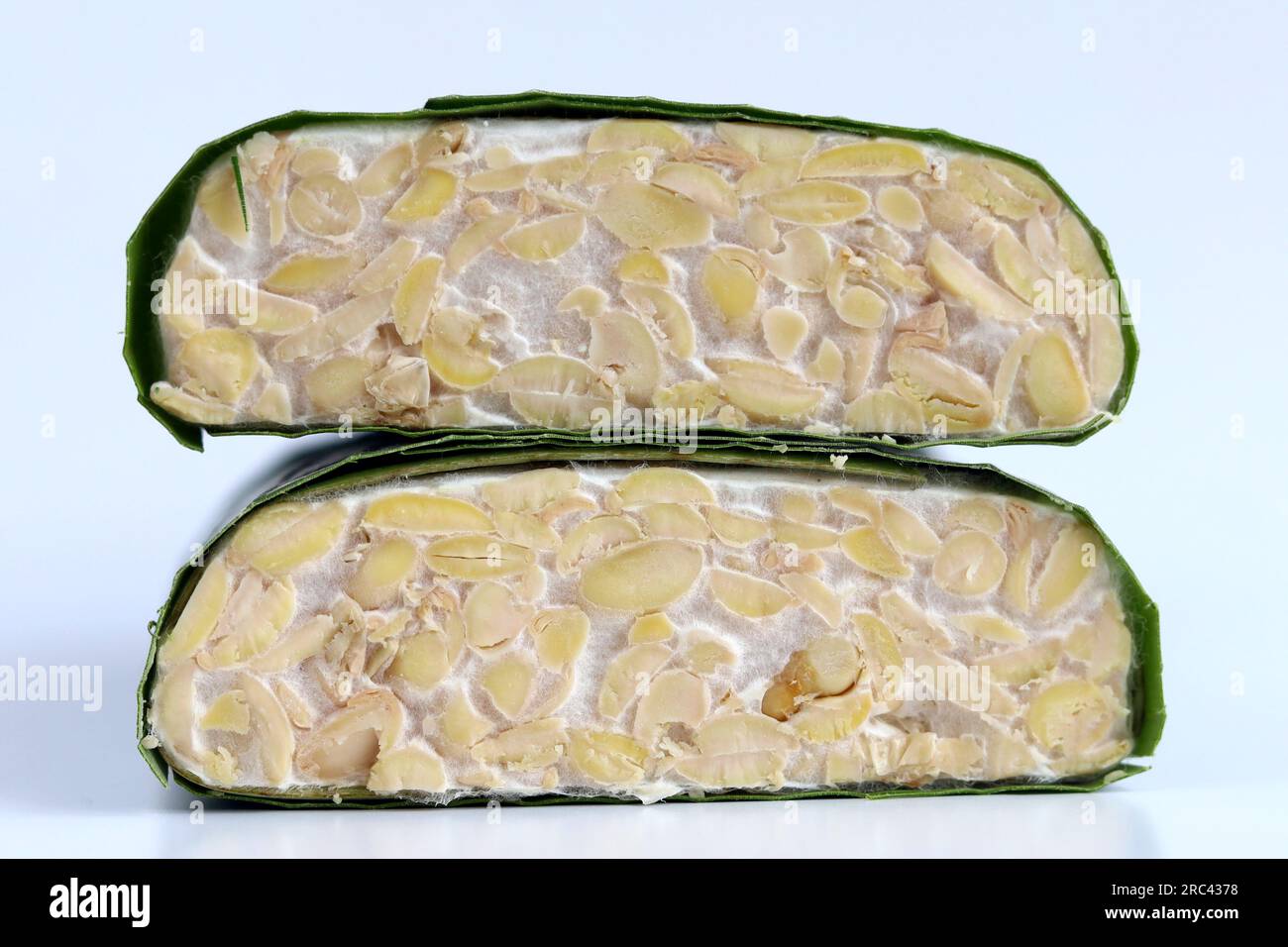 a slice of raw tempeh or tempe ,Indonesian traditional food made from ...