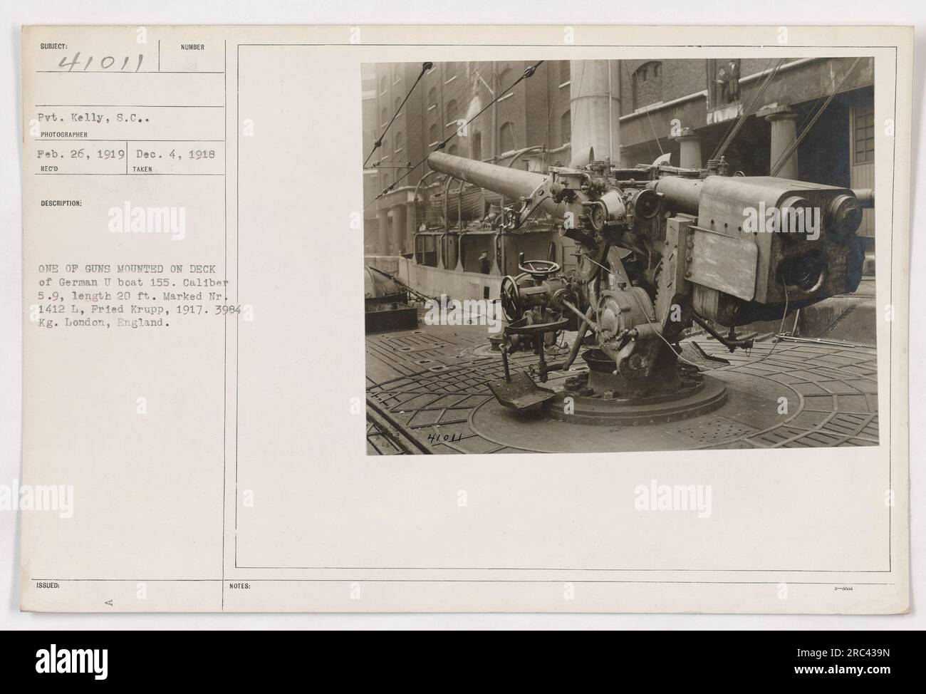 "Private Kelly photographs one of the guns mounted on the deck of ...