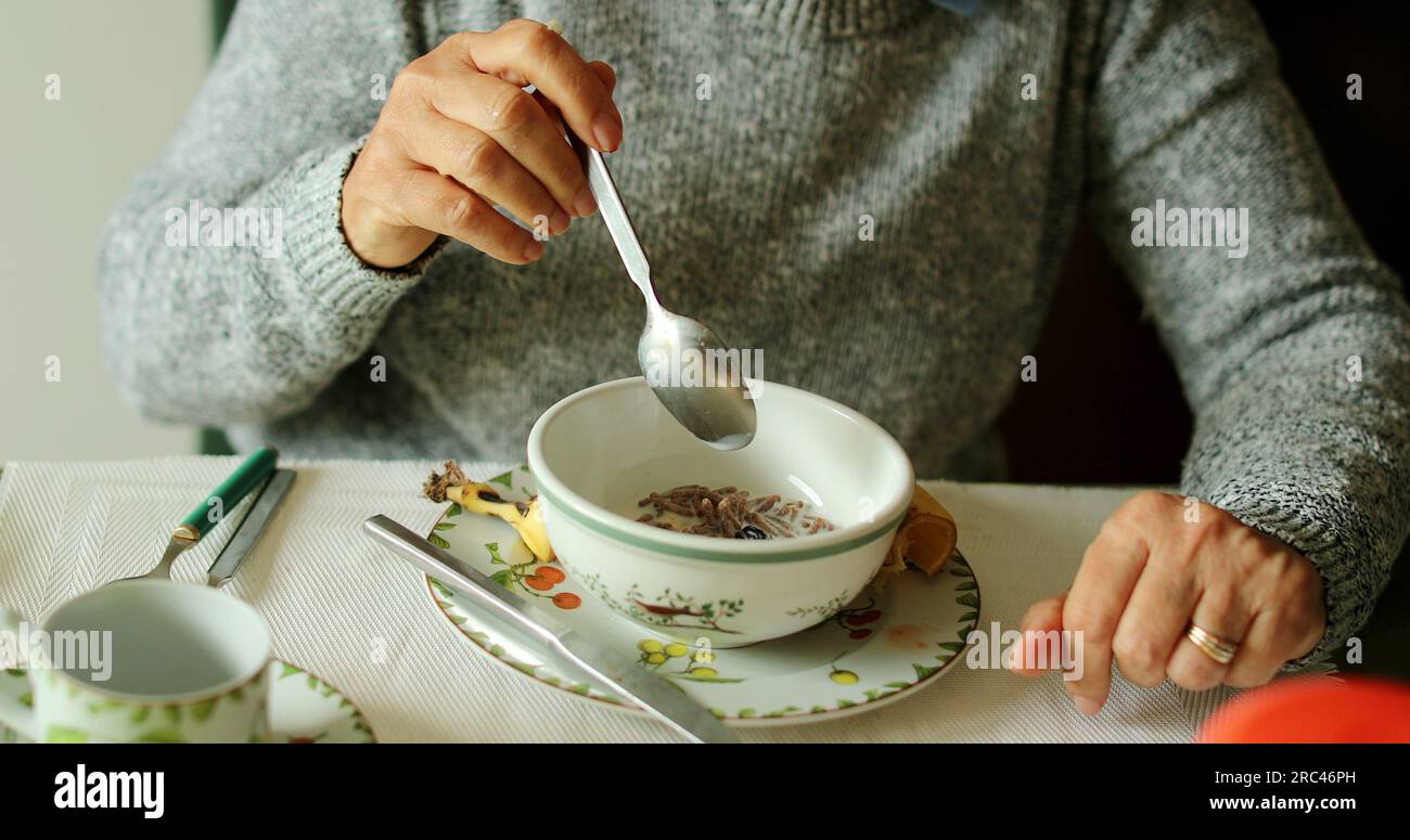 Senior woman eating breakfast older hi-res stock photography and images ...