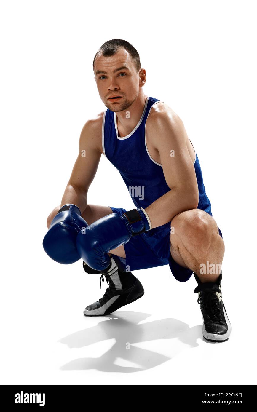 Portrait of young muscular, professional boxer posing in uniform ...