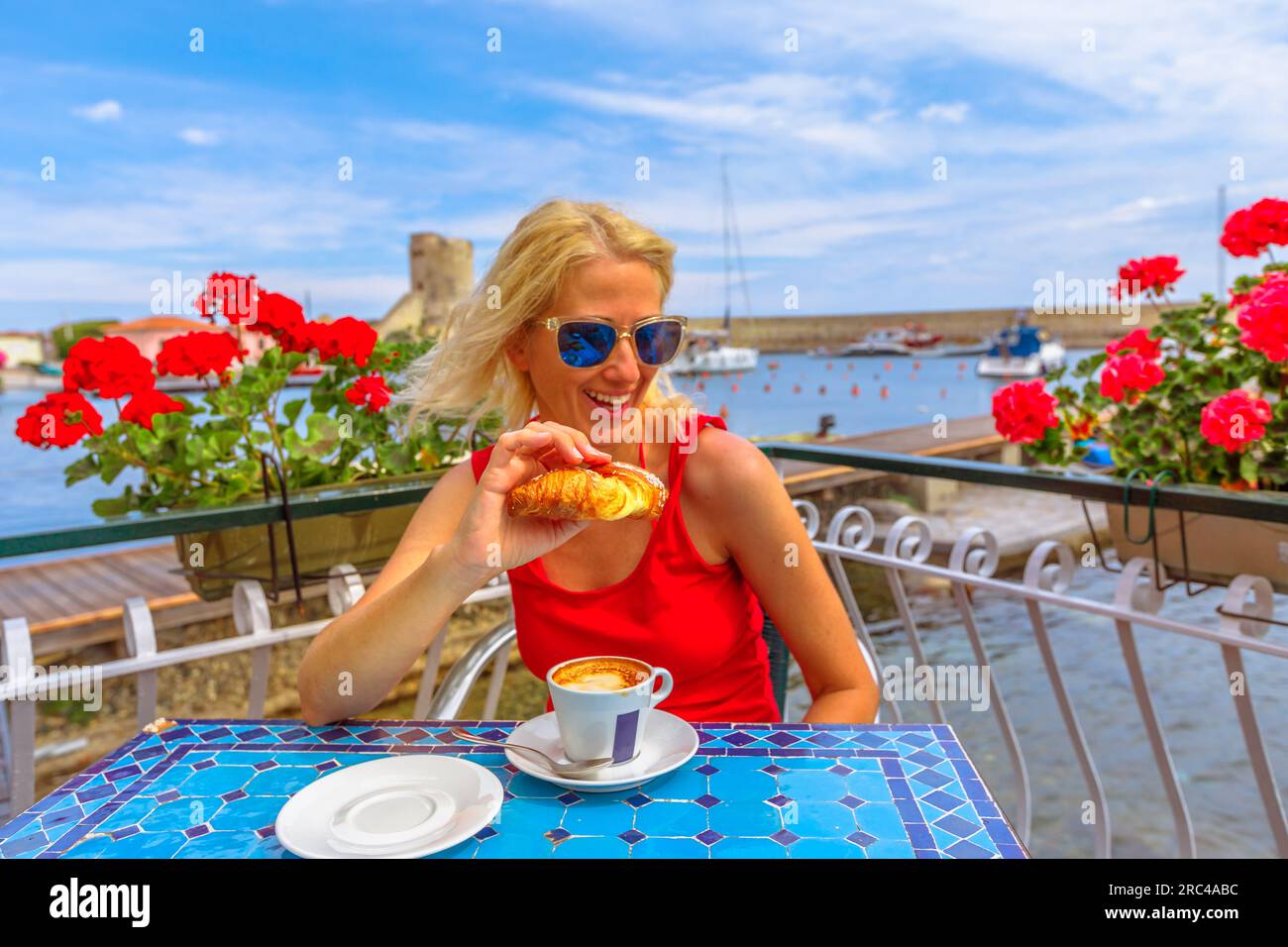 woman in a red dress, savors a delightful breakfast of croissant and ...