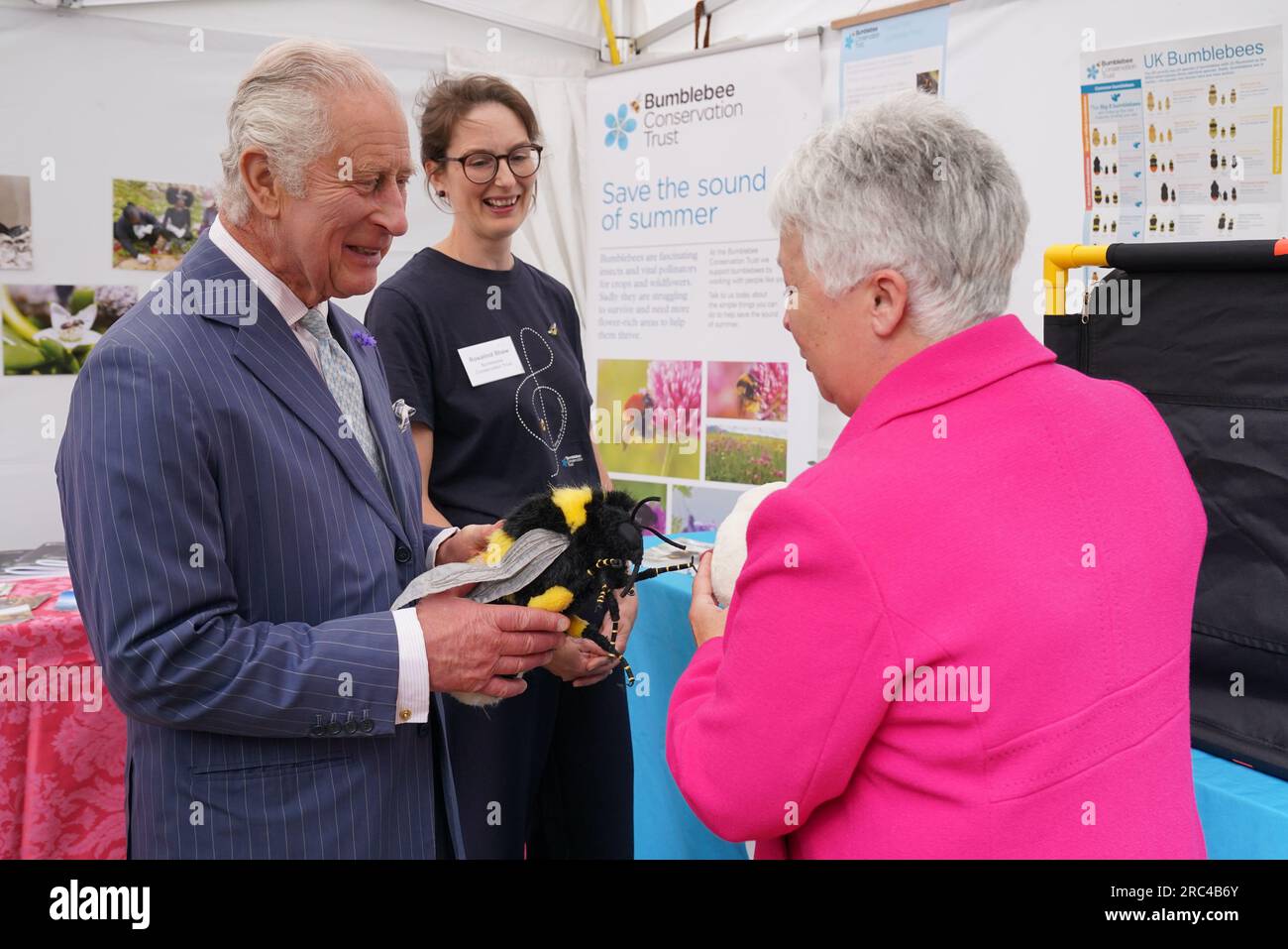 King Charles III is presented with a stuffed toy bumblebee by Gill ...