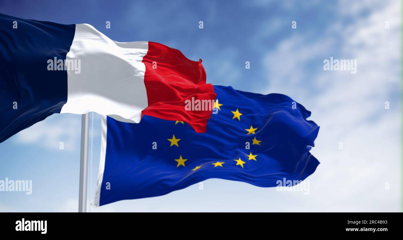 The flags of France and the European Union waving together on a clear ...