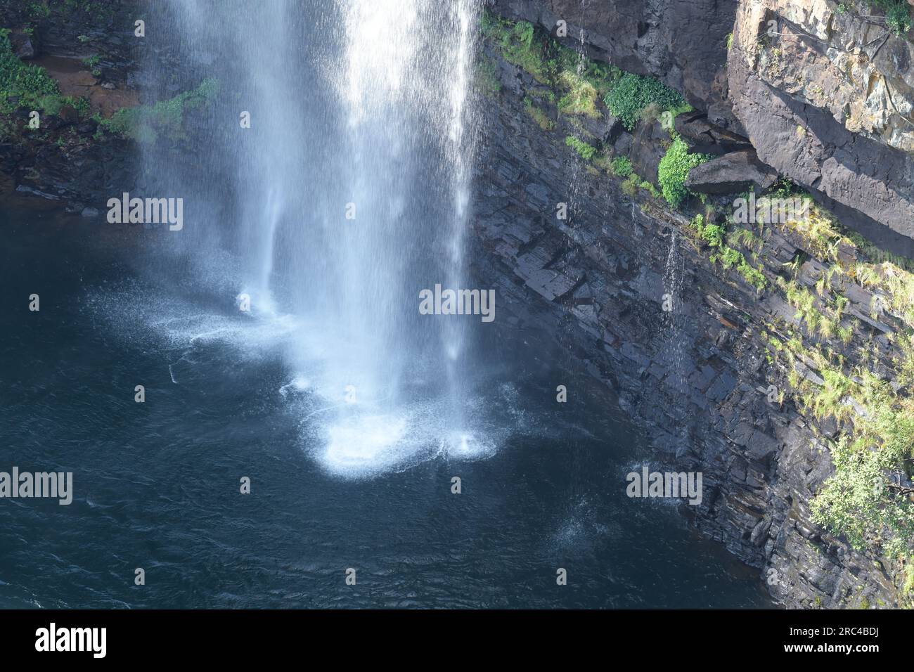 Water falling into beautiful natural pool below waterfall, abstract ...