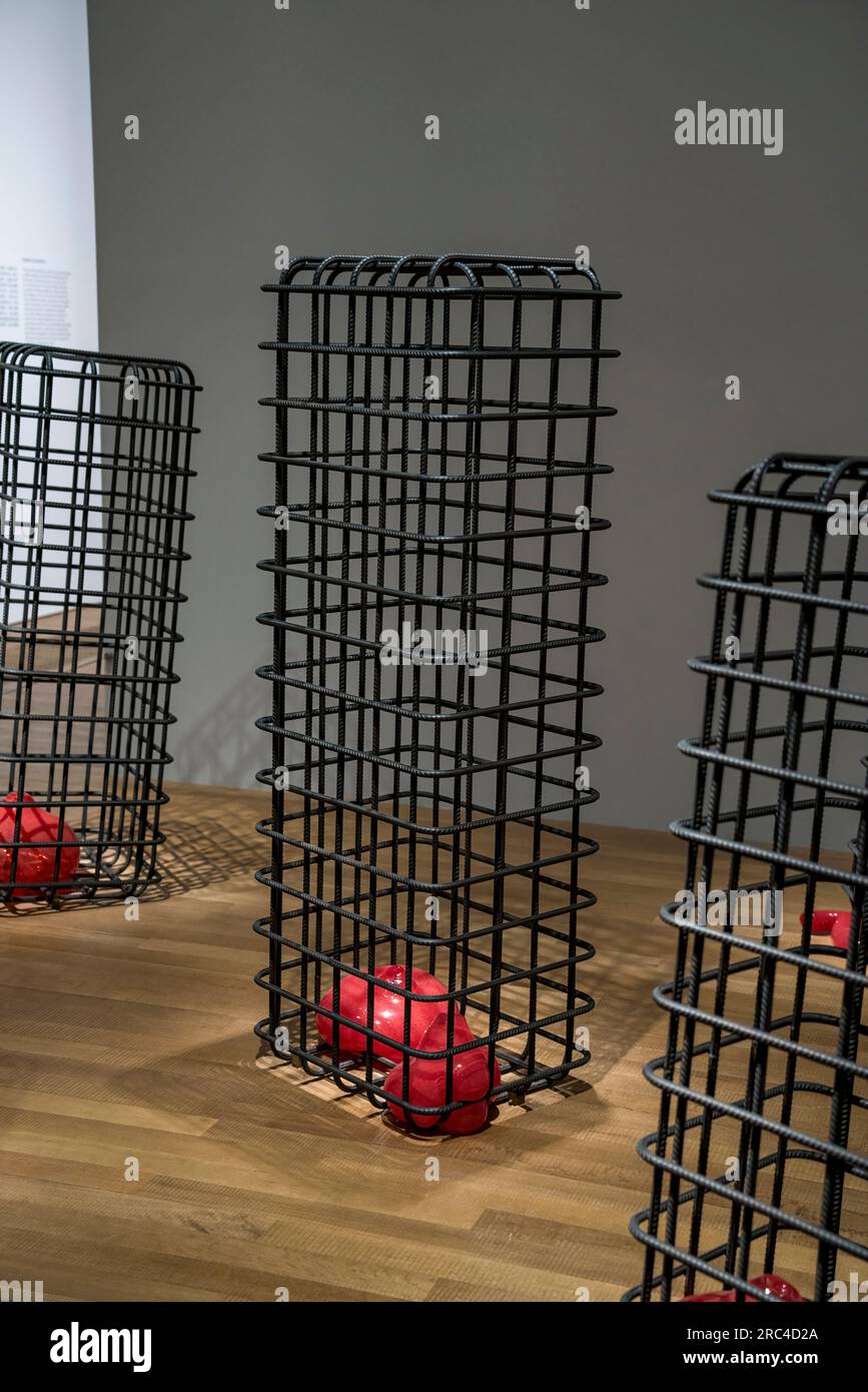 Indoor sculpture composed of iron cage and red squares Stock Photo - Alamy