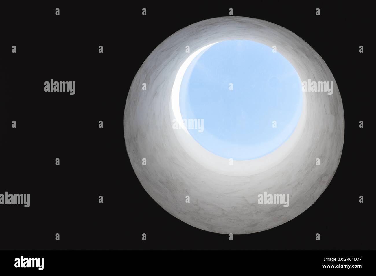Round ceiling skylight portal with blue sky behind, abstract minimal ...