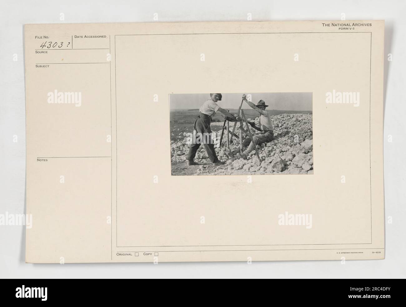 Photograph depicting American soldiers sharing a meal in a wartime camp ...