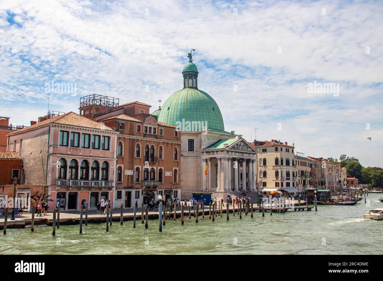Touristic gondola in narrow grand canal between buildings in Venice ...