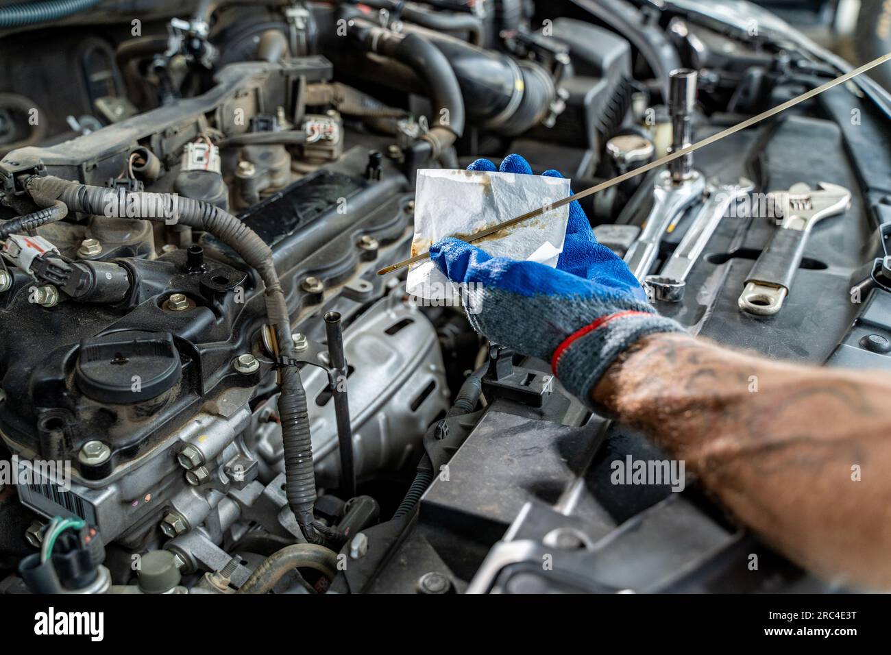 Male mechanic checking car engine hi-res stock photography and images ...