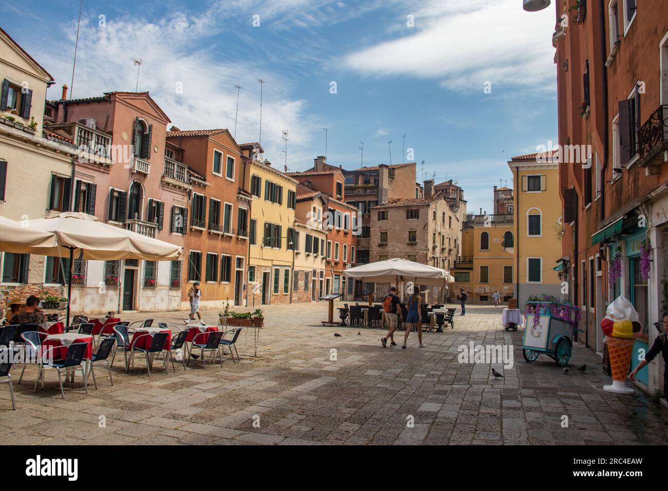 Touristic gondola in narrow grand canal between buildings in Venice ...