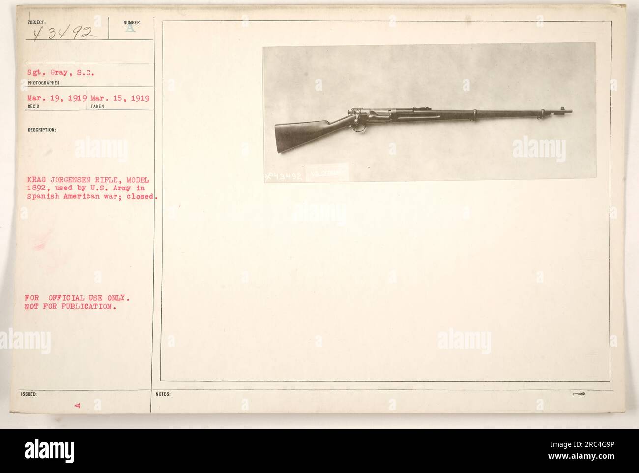 Soldiers inspect a Krag-Jorgensen rifle, Model 1892, used by the U.S ...