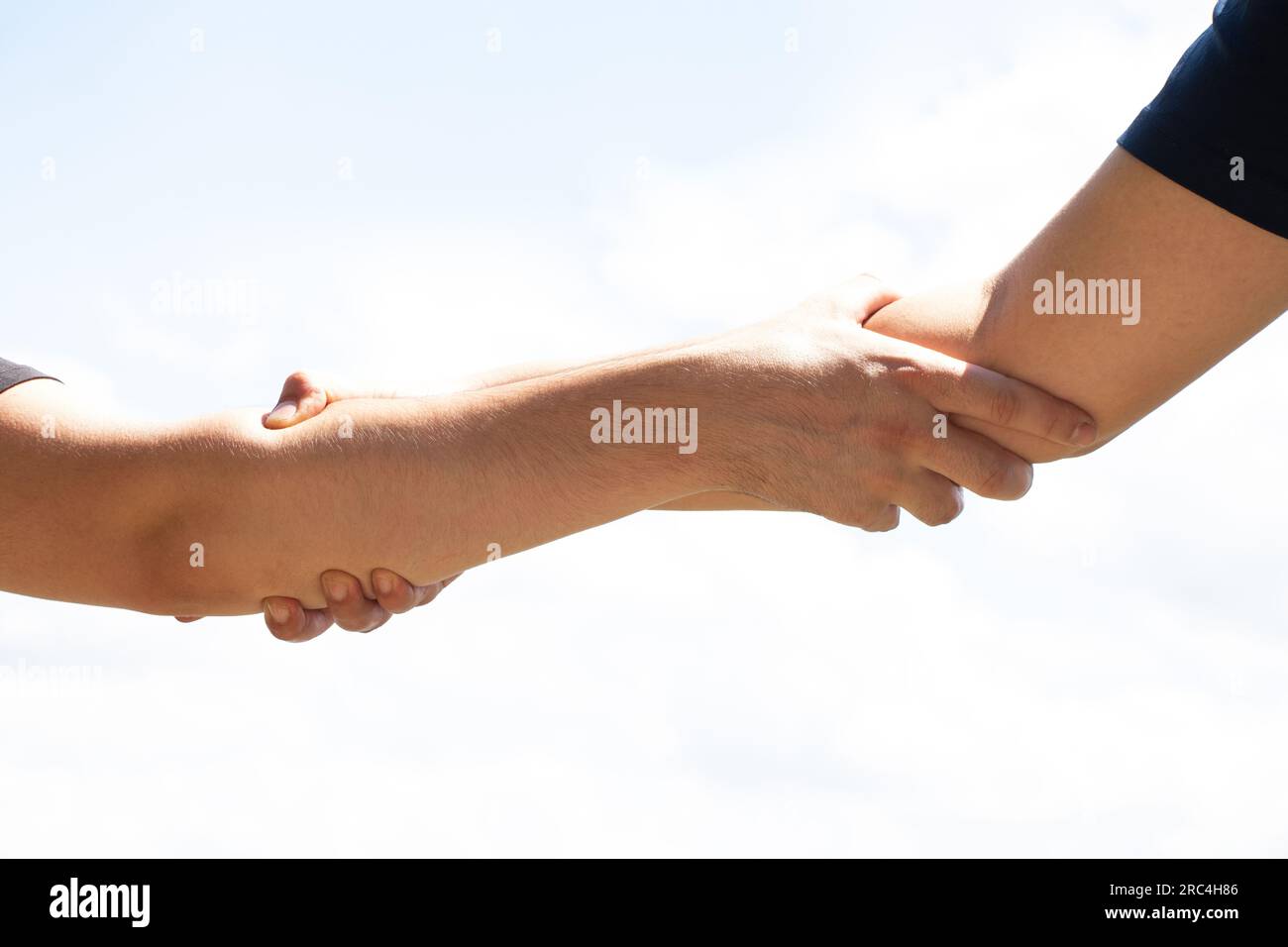 Two men held out their hands to each other as a sign of friendship and ...
