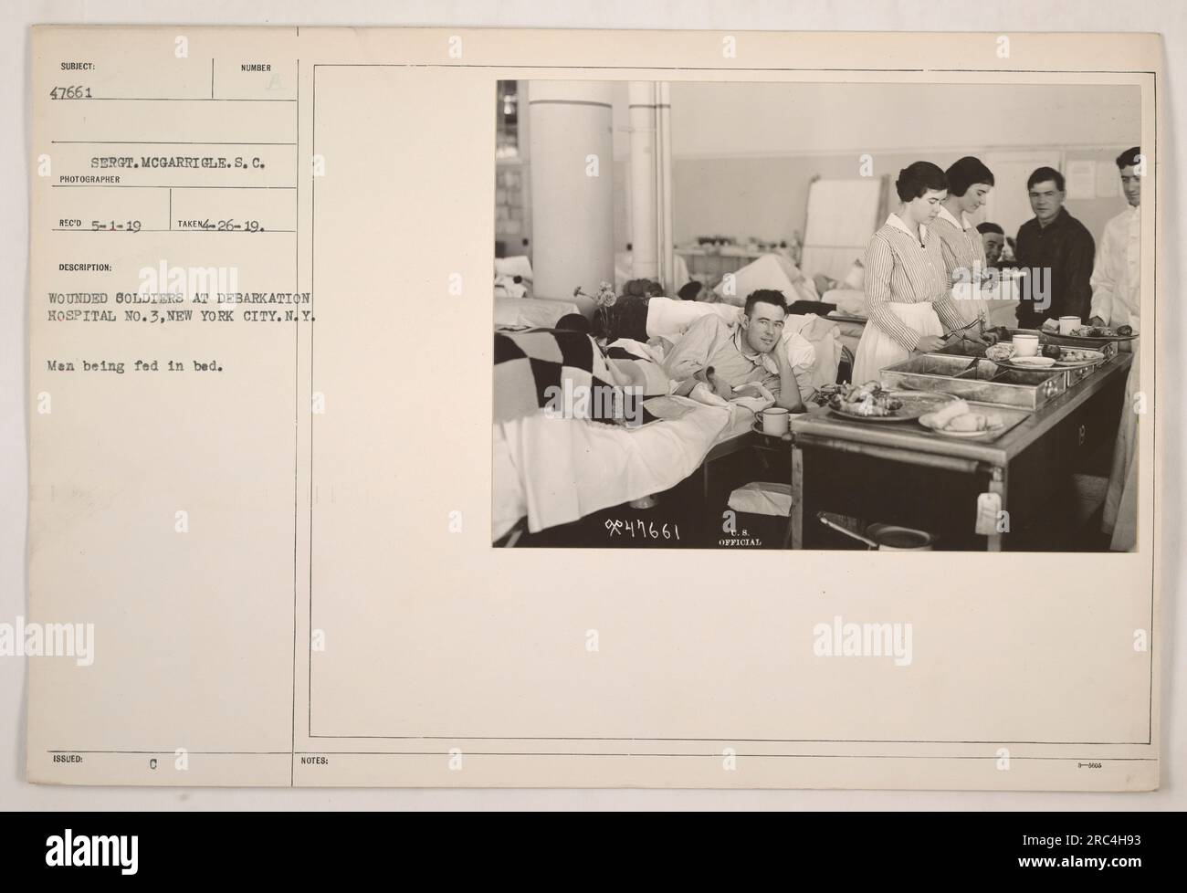 Wounded soldiers receiving food while bedridden at Debarkation Hospital ...