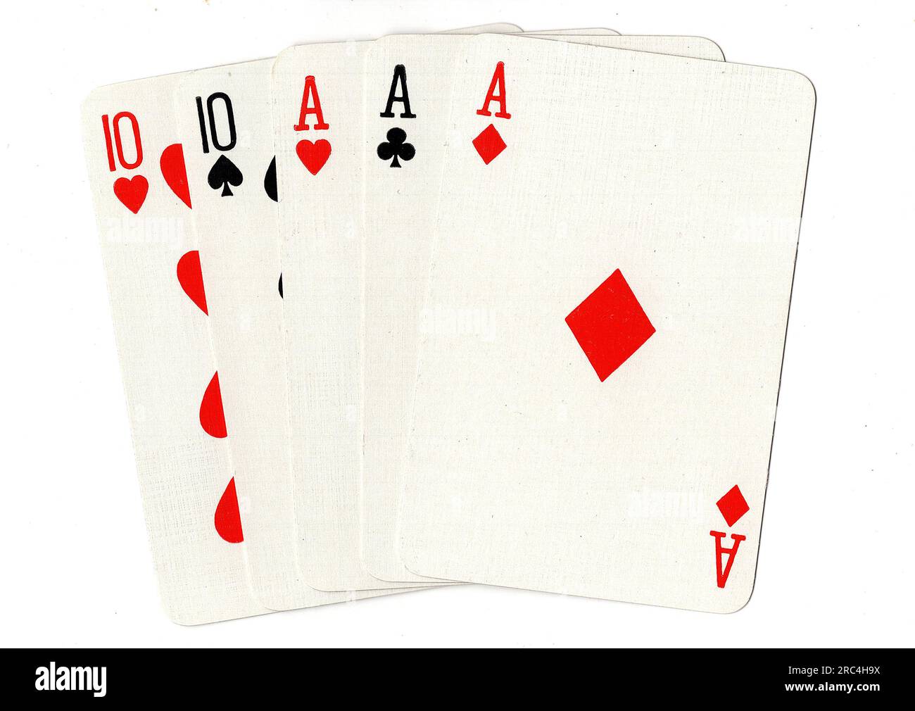 A poker hand of playing cards showing a full house of aces and tens on ...