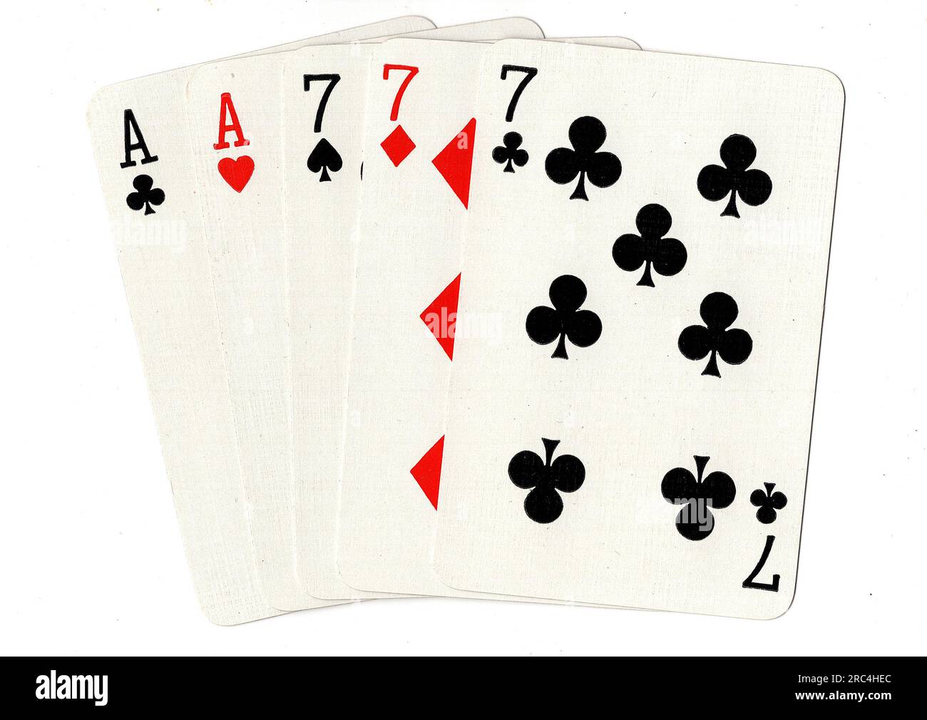 A poker hand of playing cards showing a full house of sevens and aces ...