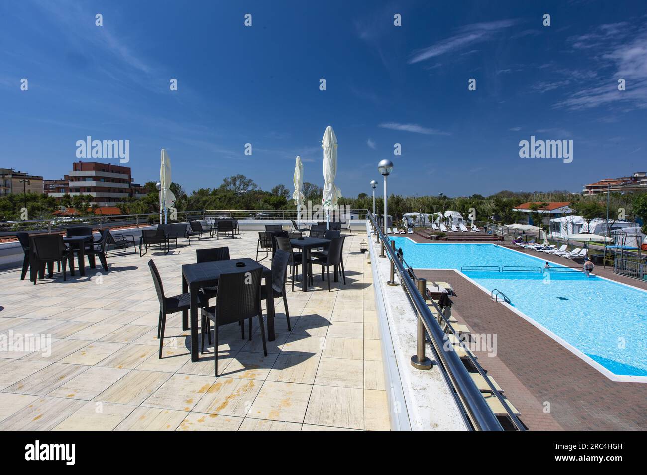 terrace of the restaurant bar on the swimming pool of the village Stock ...