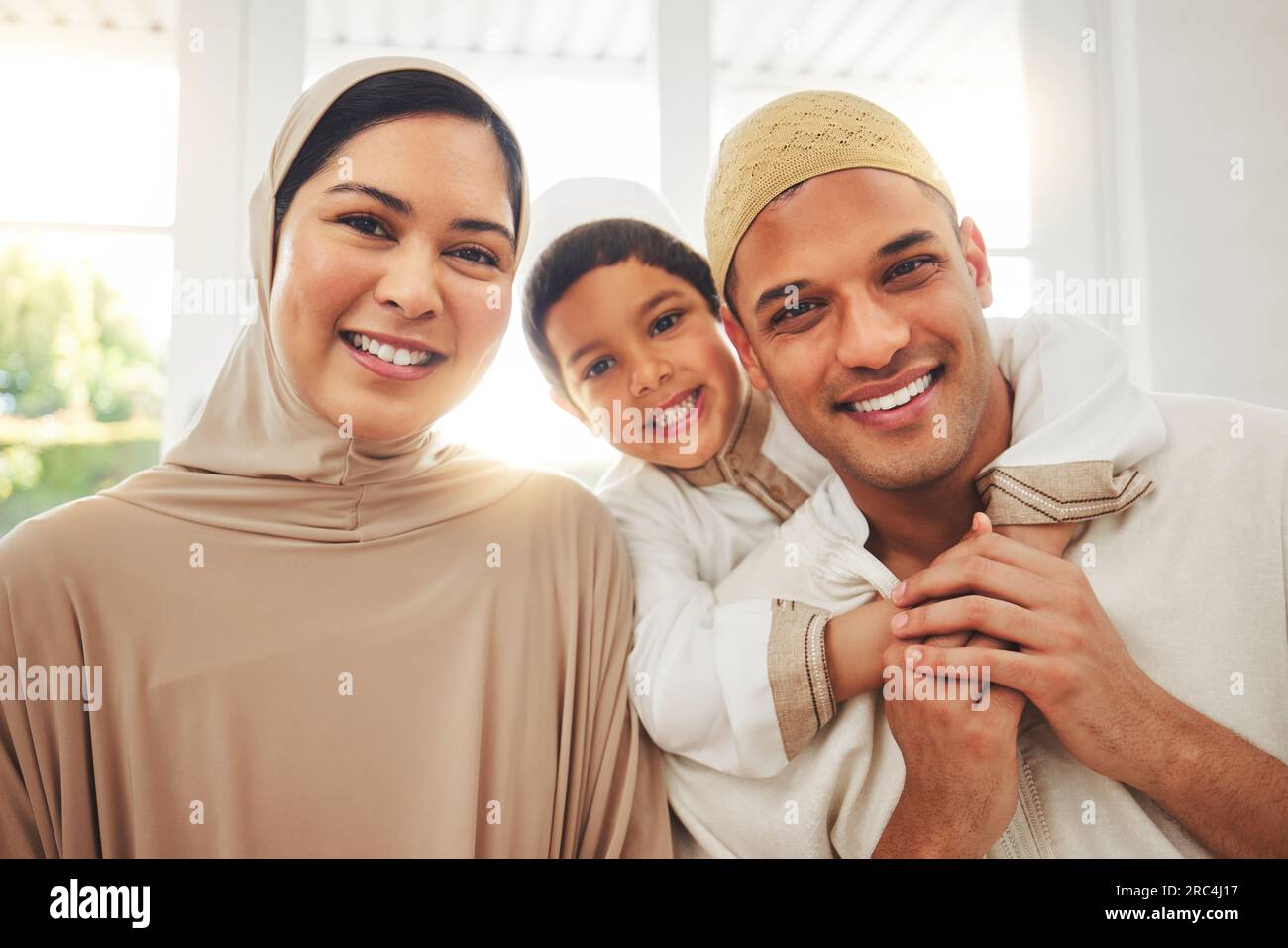 Portrait, hug and happy muslim family of mother, father and child smile ...