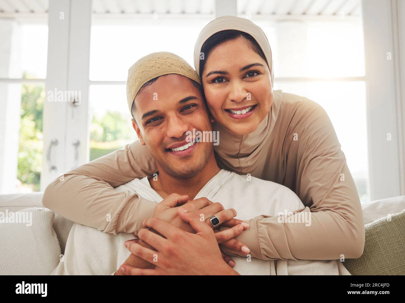 Portrait, Islam and happy couple hug on couch with smile, culture and ...