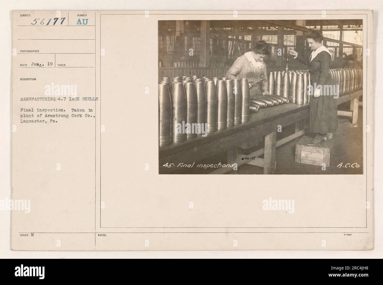 Workers conducting a final inspection of 4.7 inch shells in the ...