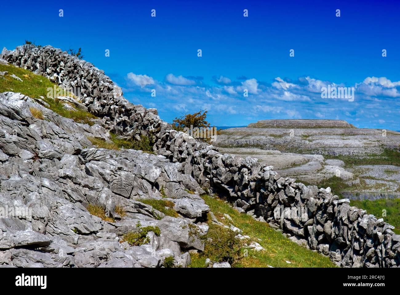 Dry stone wall on the Burren looking towards Mullaghmore, County Clare ...