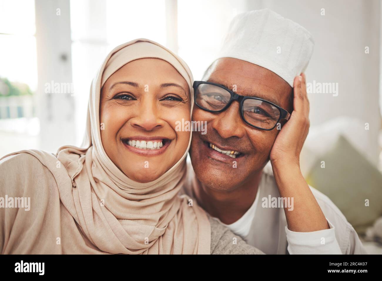 Portrait, Islam and senior couple in living room for Eid with smile ...