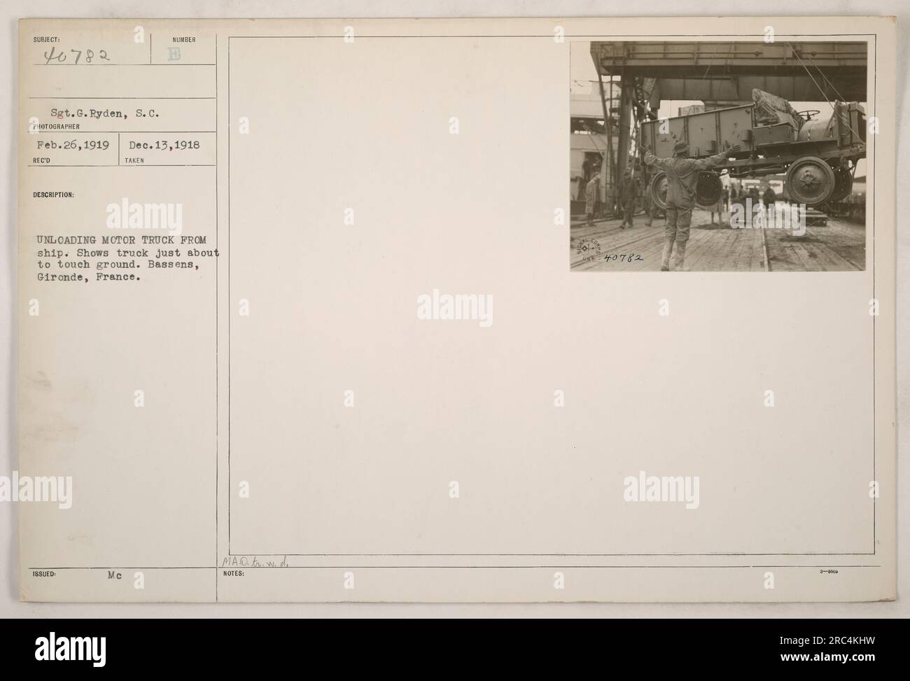 Sergeant G. Ryden unloading a motor truck from a ship. The photograph ...