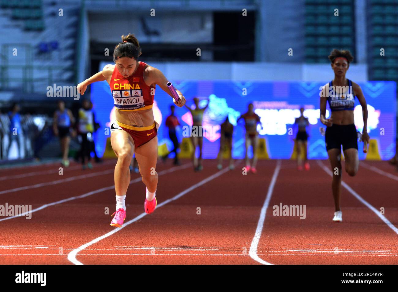 Bangkok, Thailand. 12th July, 2023. Ge Manqi (front) of China sprints during the women's 4X100 ...