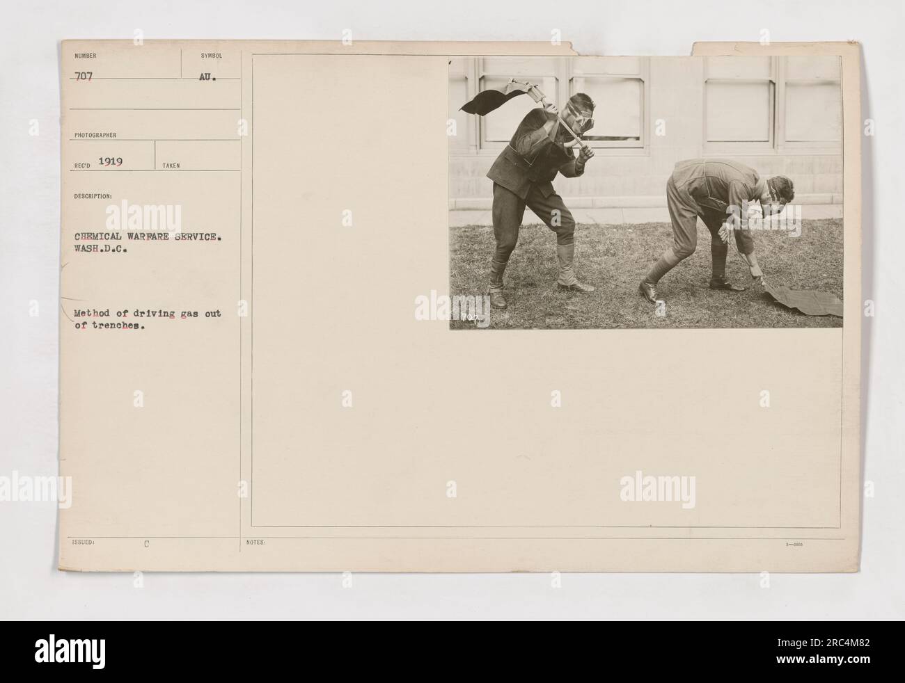 Soldiers using a fan powered machine to disperse gas from trenches ...