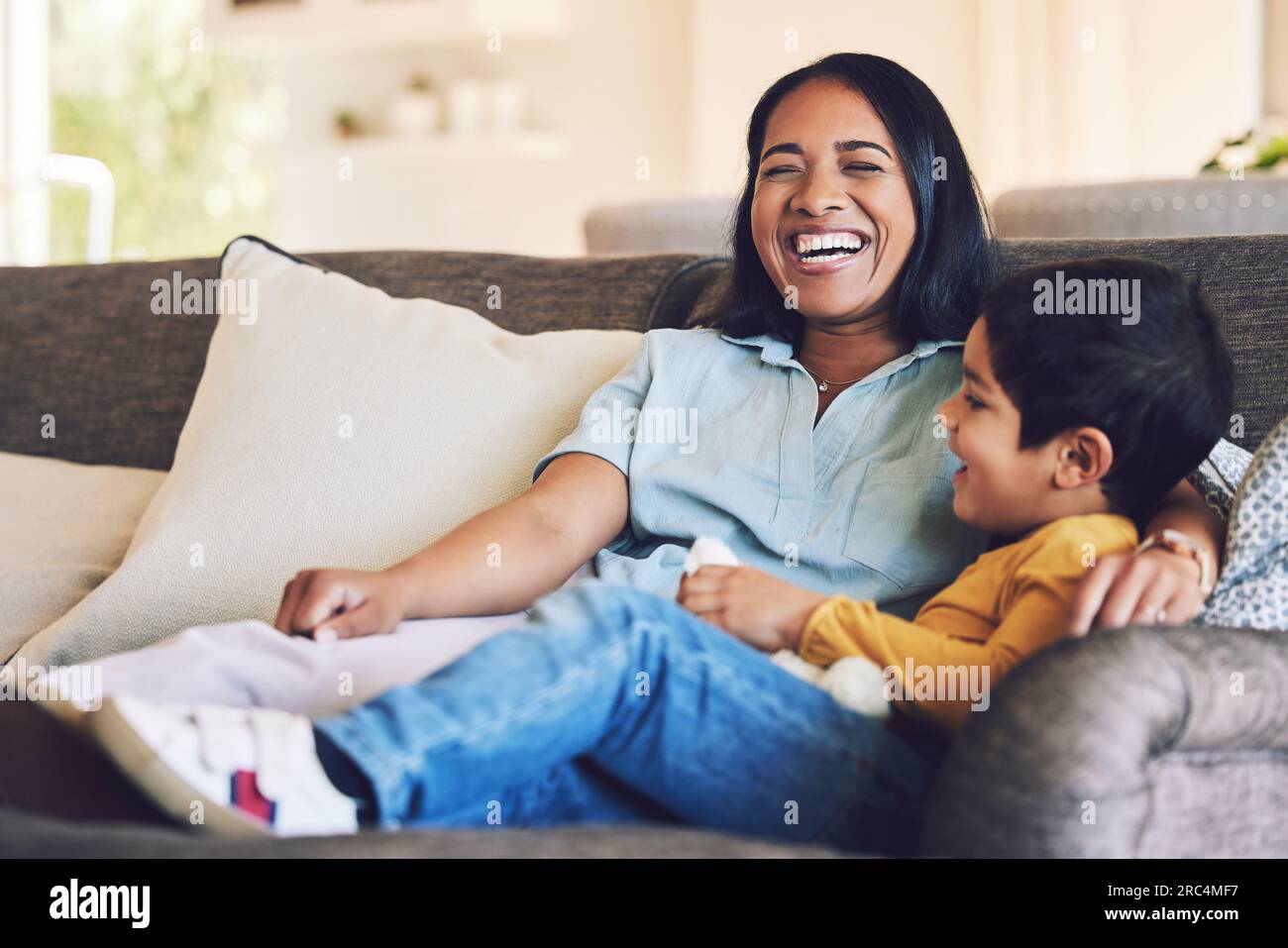 Funny, mother and boy on a couch, love and quality time with happiness ...