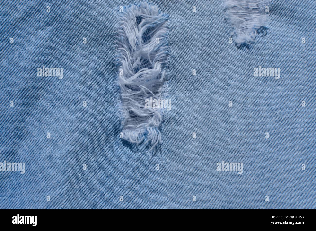 Close-up detail of denim texture, highlighting the intertwined lines ...