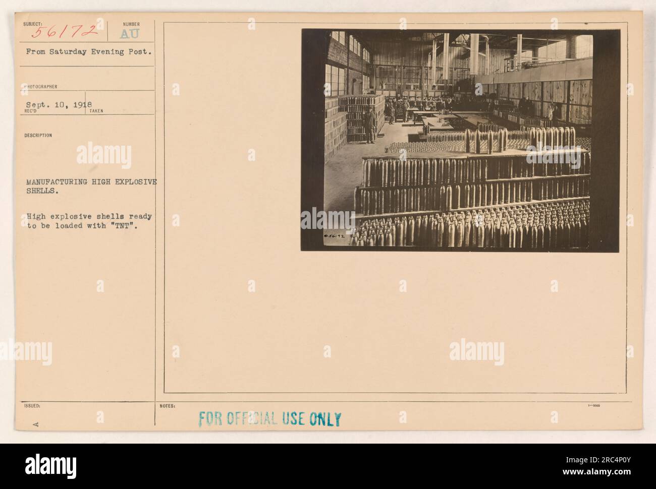 Workers preparing high explosive shells for loading with TNT during ...
