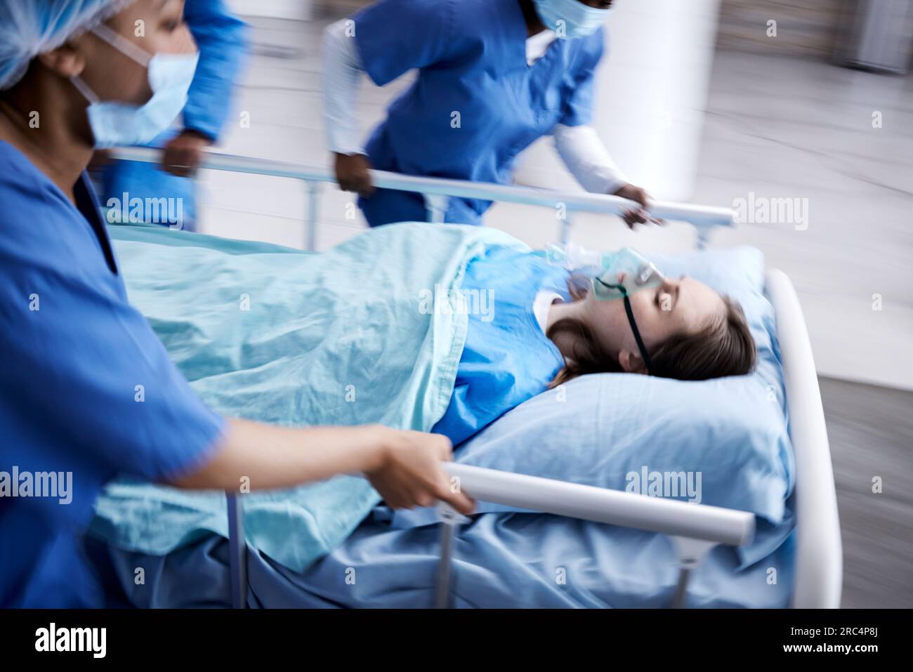 Surgery, emergency and running with doctors and patient in hospital for ...