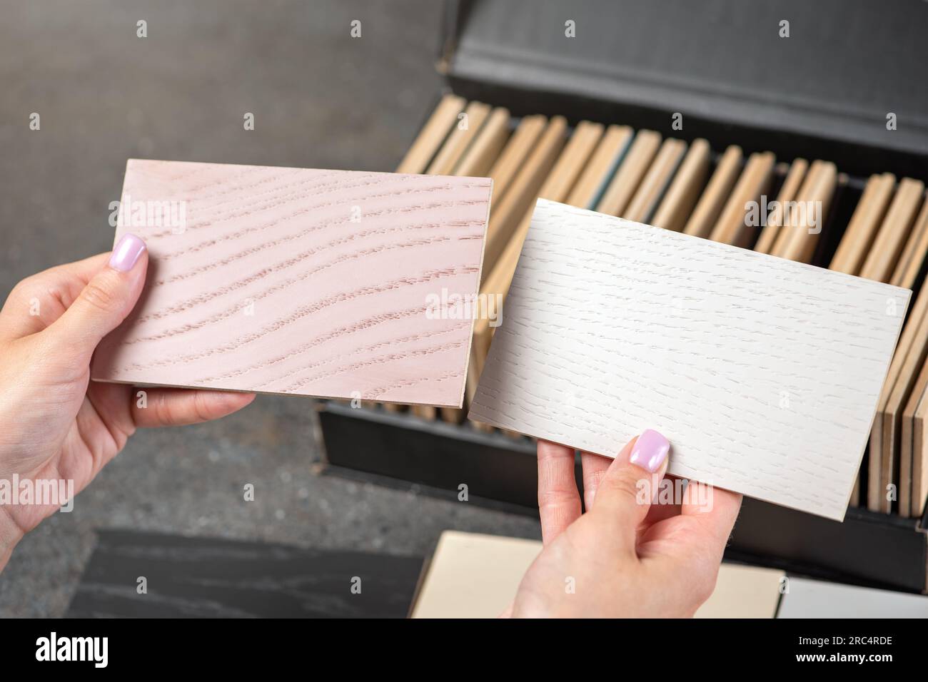 Choice of floor color from wood samples. A female designer chooses a ...