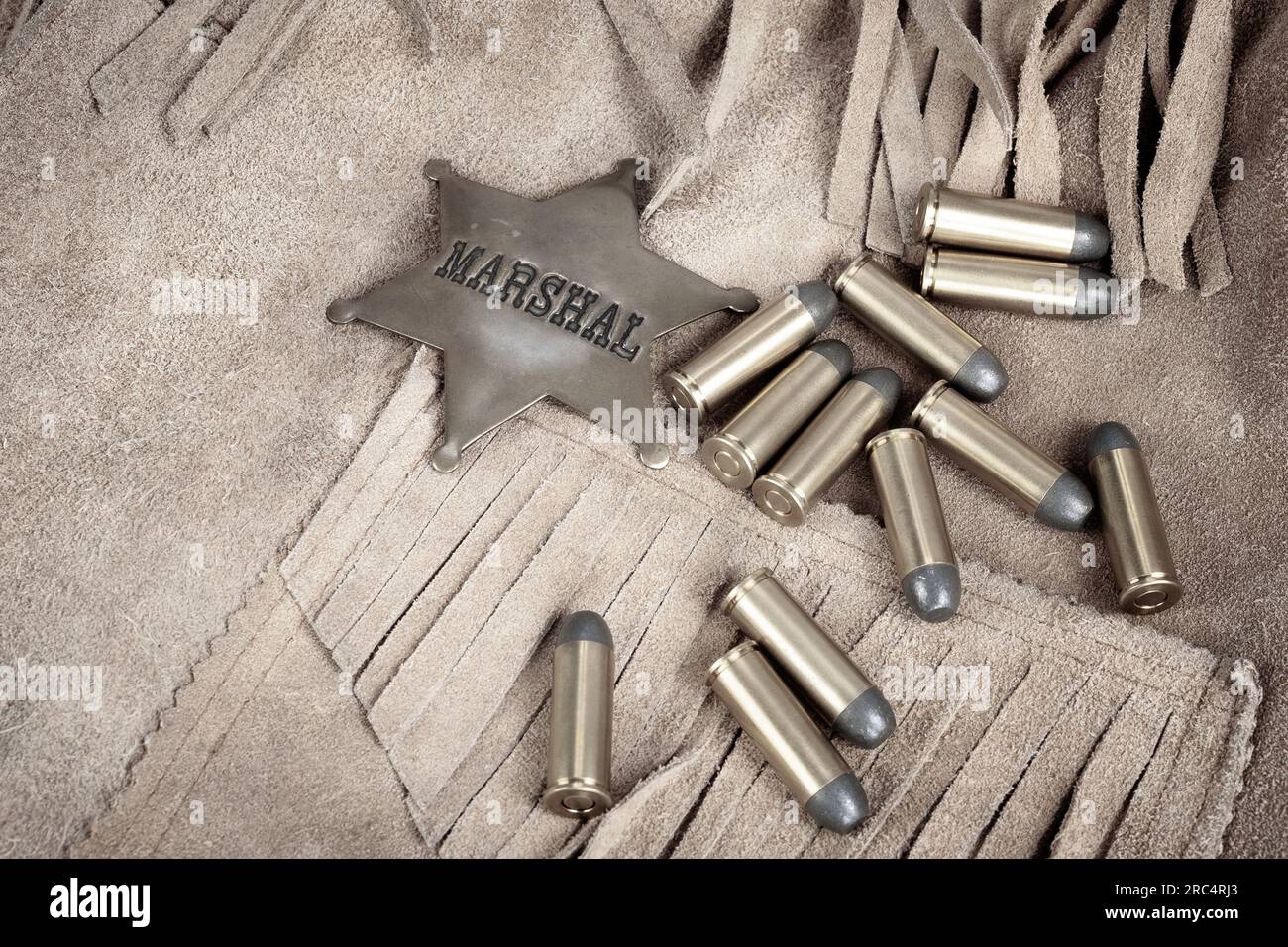 Old west marshal badge with ammunition background Stock Photo - Alamy