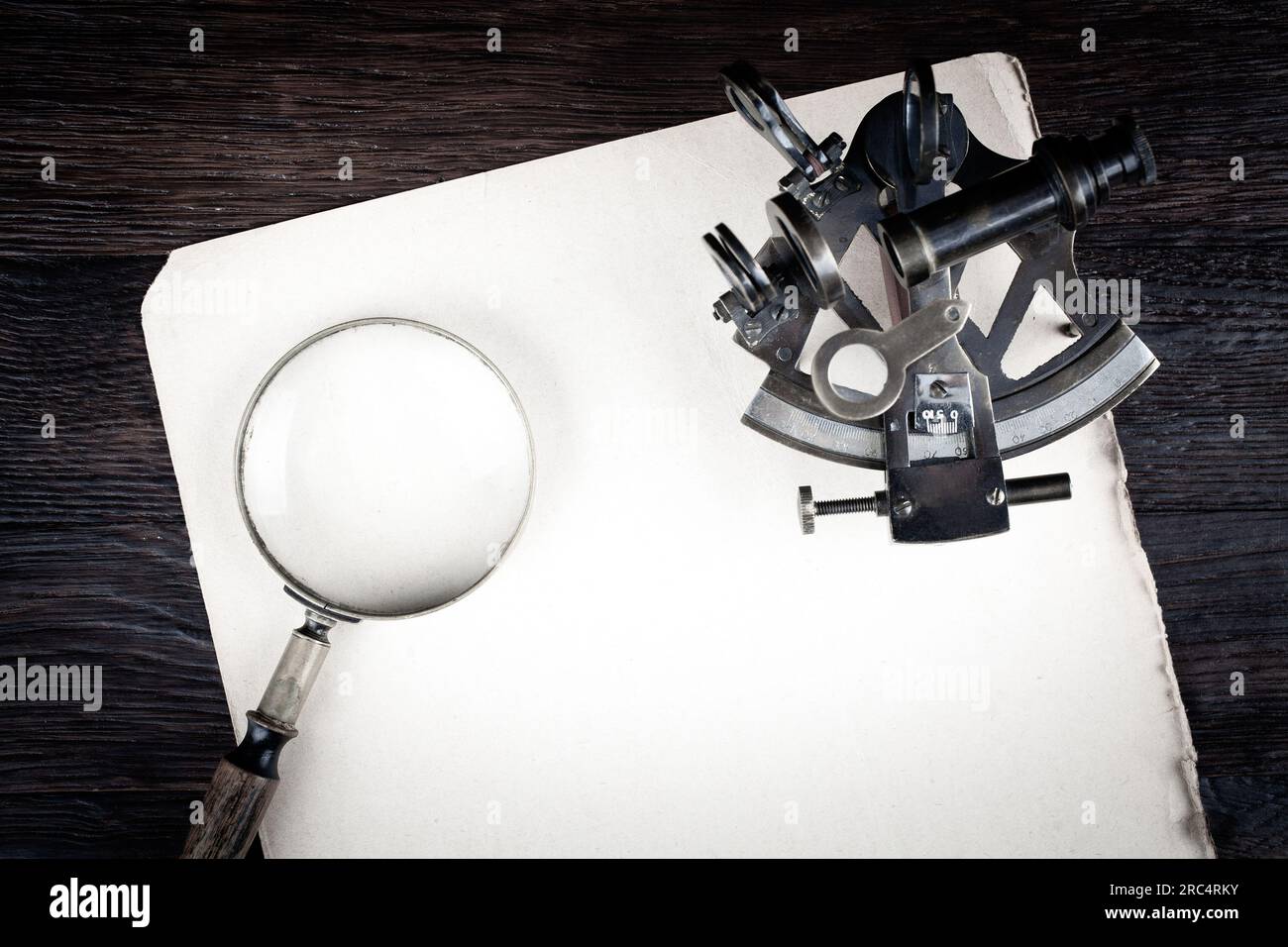 Antique bronze sextant on old paper background Stock Photo - Alamy