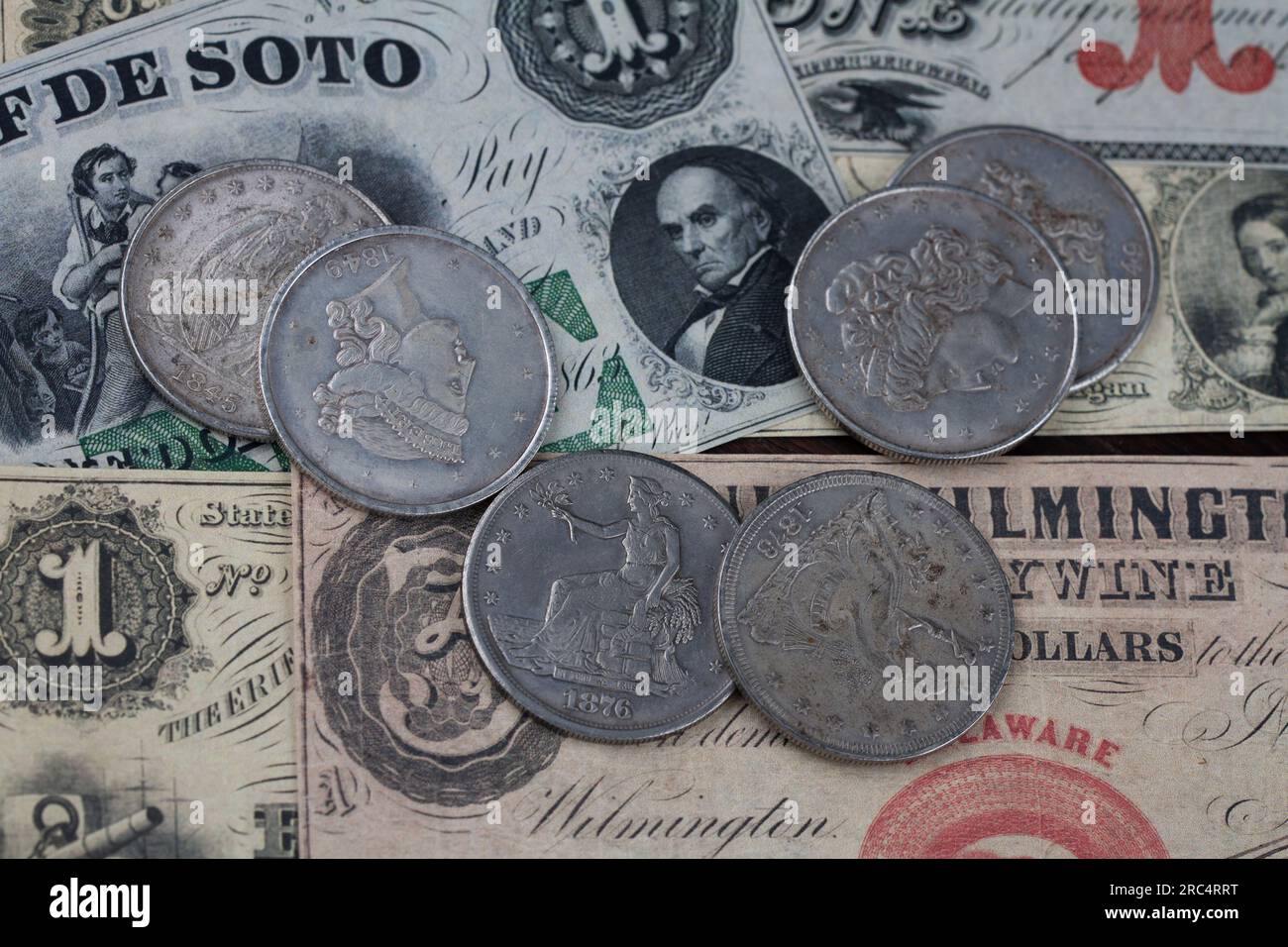 Old west US banknotes and silver certificates with silver dollar coins ...