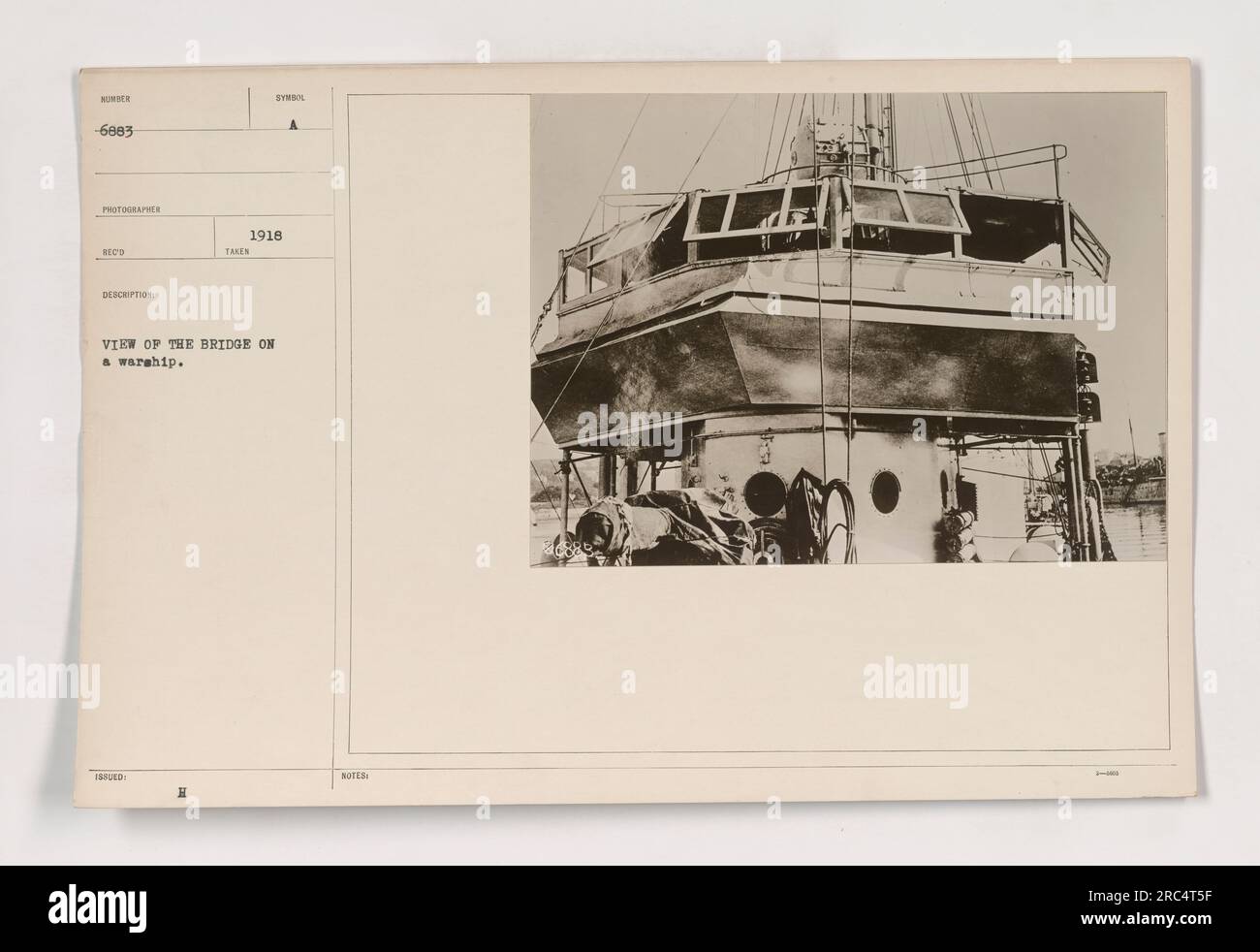 The photograph shows a view of the bridge on a warship during World War ...