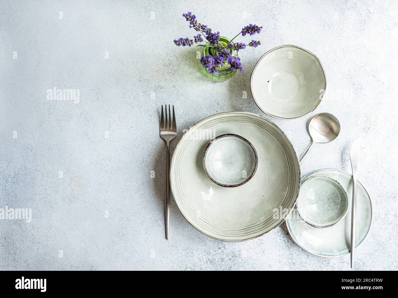 Top view of monochrome table setting in grey color with fresh aromatic ...