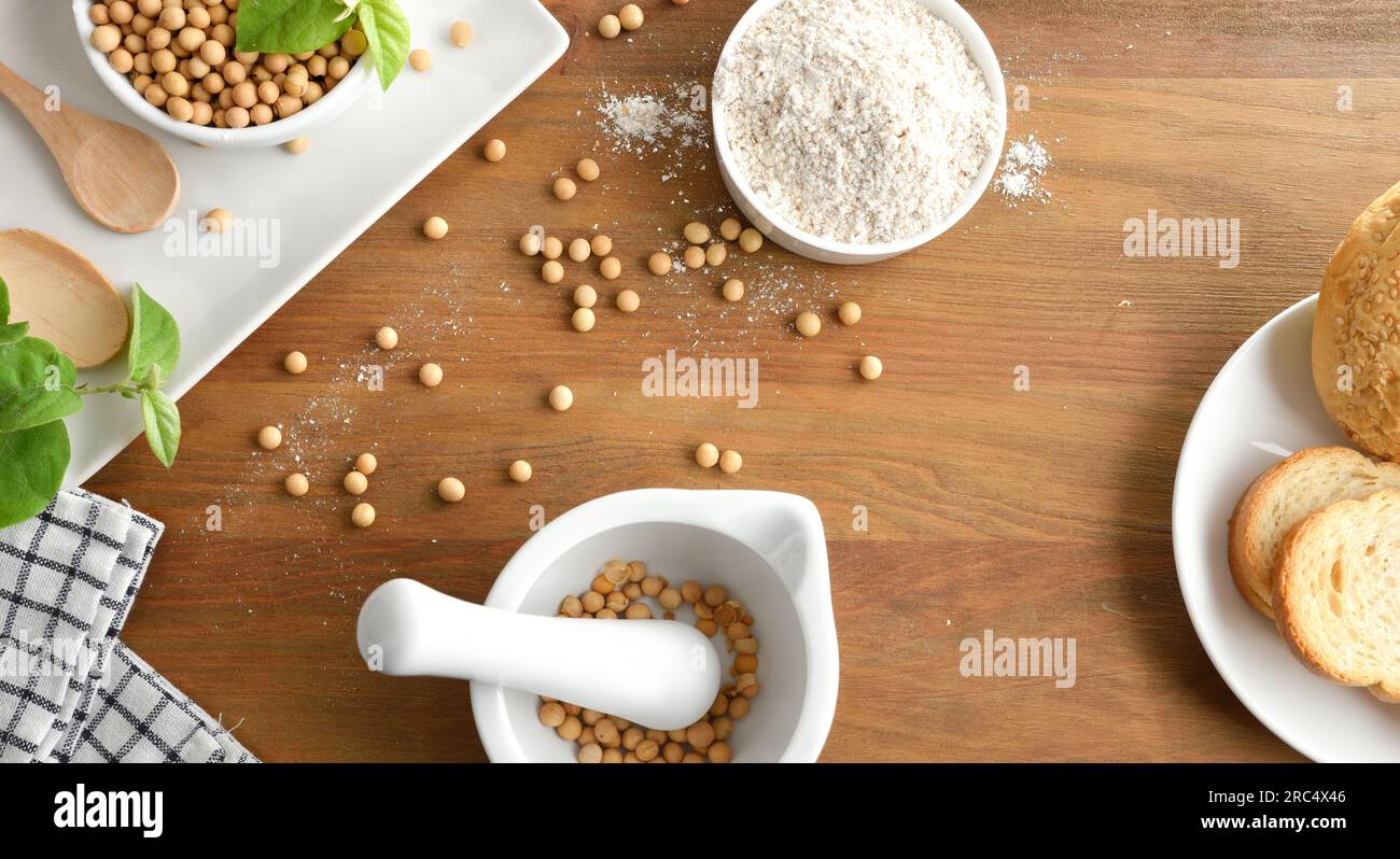Soy flour freshly made at home with mortar, grains, and various kitchen ...